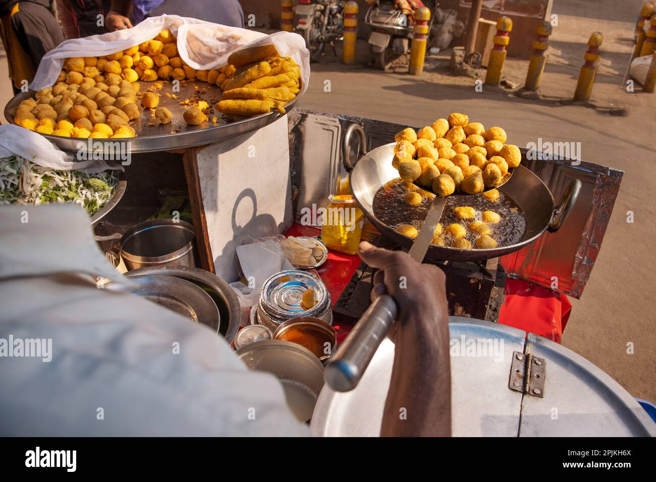 Male vendor making aloo vonda at his roadside food stall Stock Photo ...