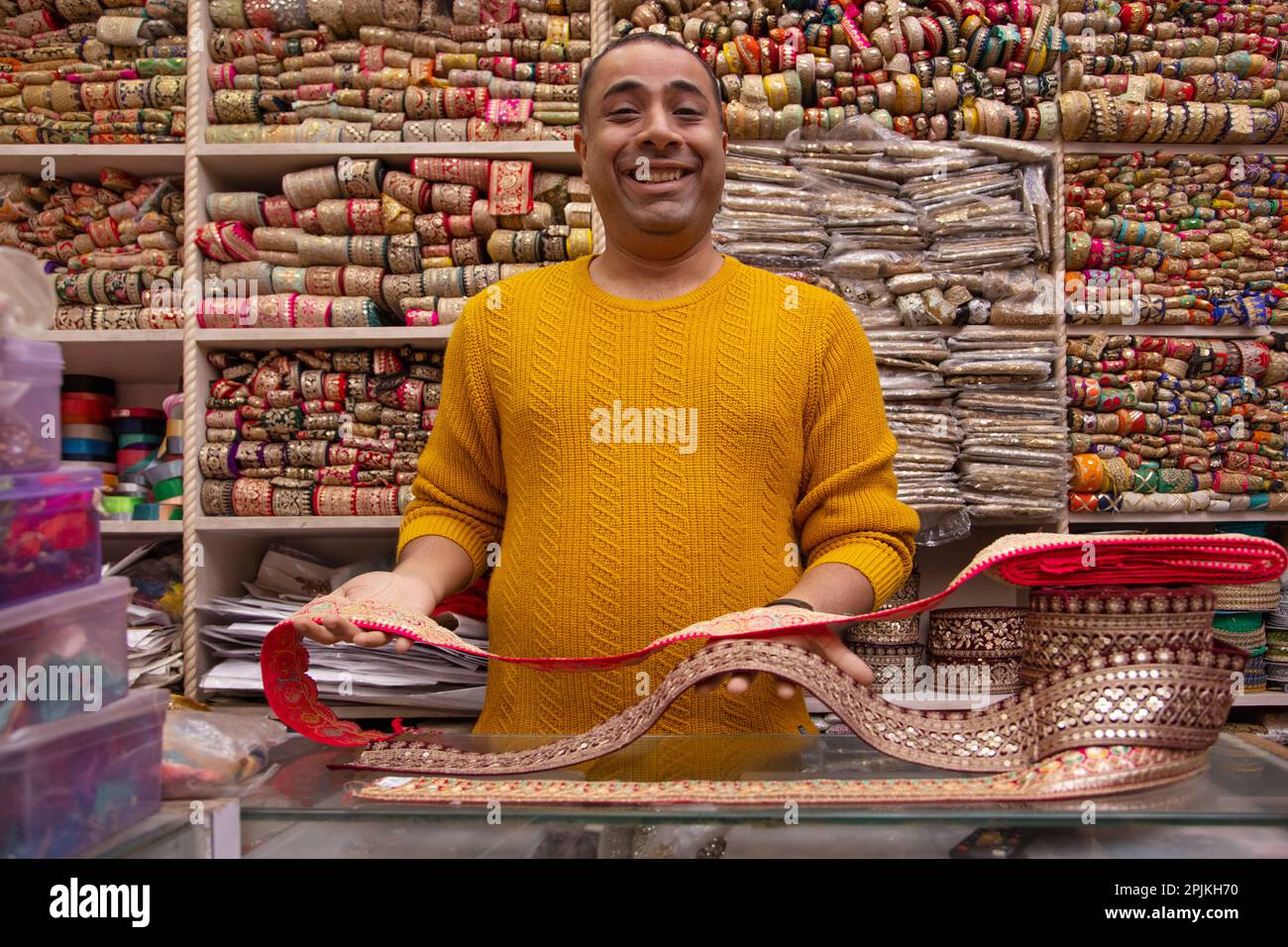 Portrait of a cheerful male shop keeper standing at his lace shop Stock ...