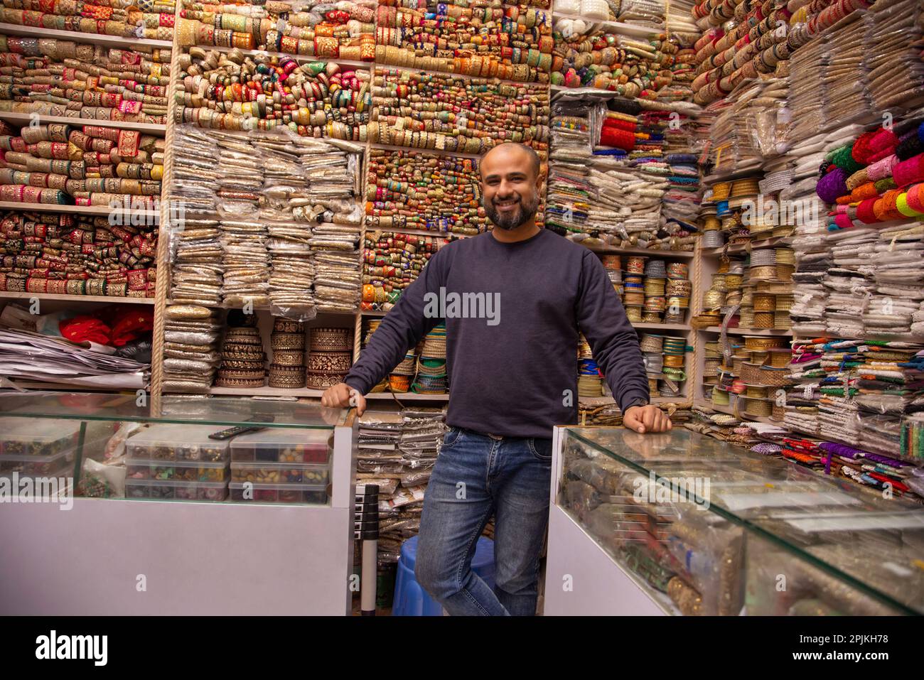 Portrait of a cheerful male shop keeper standing at his lace shop Stock ...