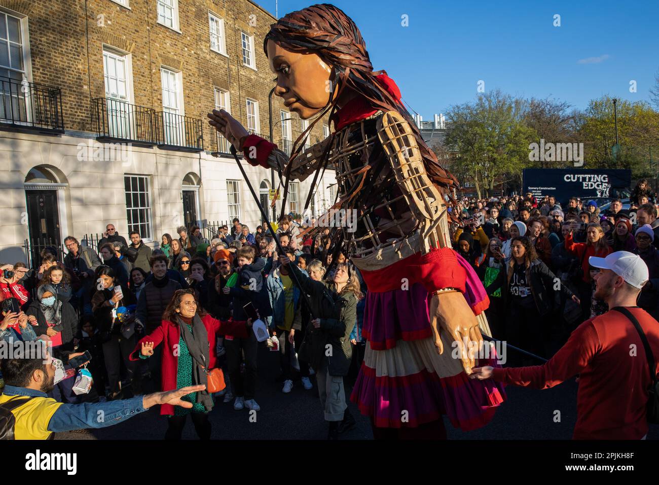 London, UK. 2nd April, 2023. Local residents dance with Little Amal, a ...