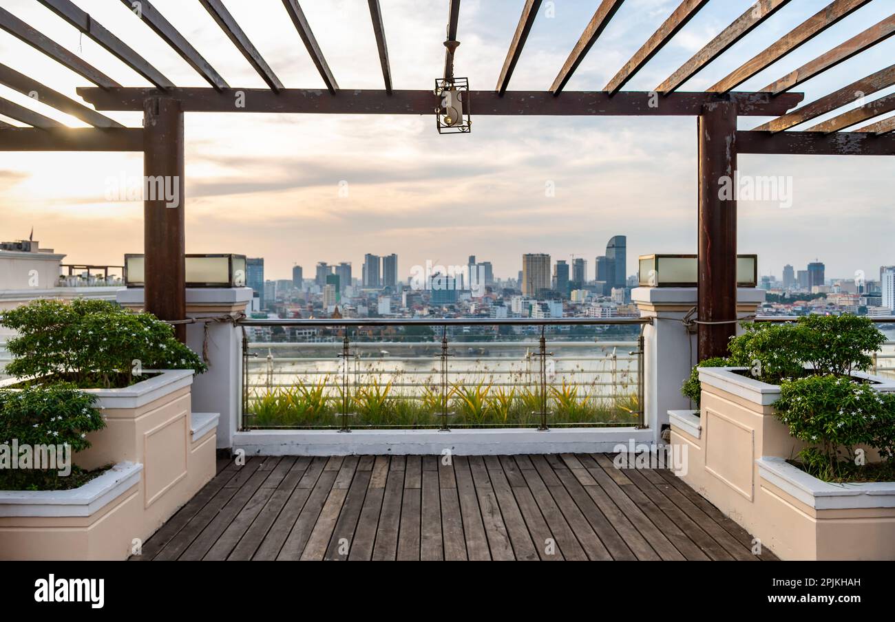 Framed by wooden beams of a high balcony,with decorative plants,the ...