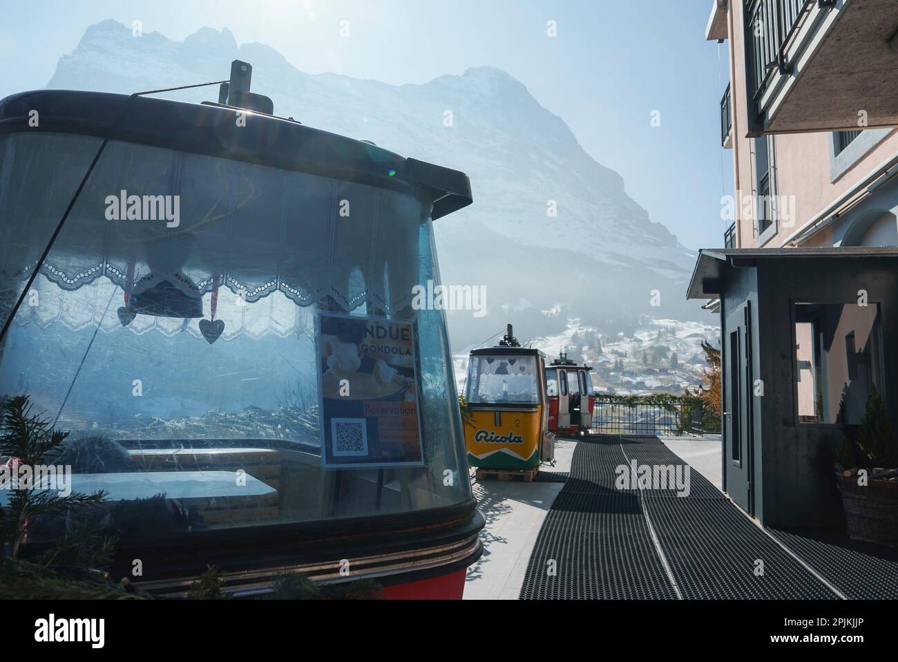 Overhead cable cars in front of sky outside luxury hotel on sunny day ...
