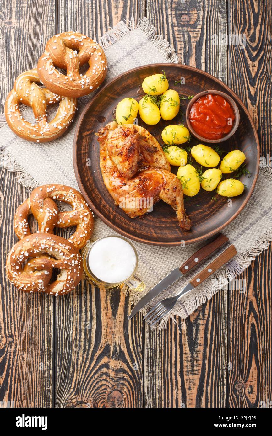 Bavarian roast chicken Hendl with boiled potatoes served with beer and ...