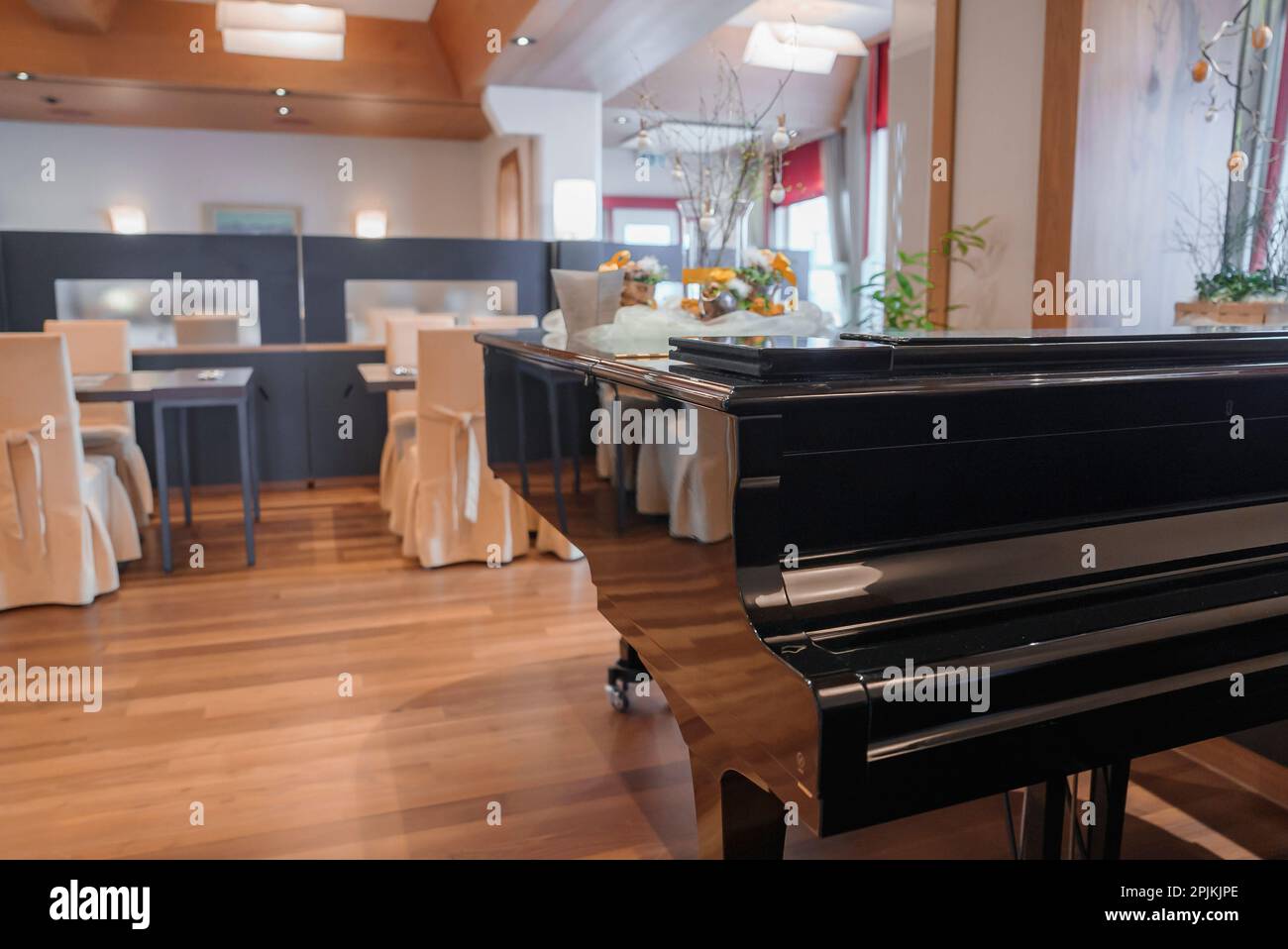 Grand piano in illuminated restaurant of luxury hotel Stock Photo - Alamy