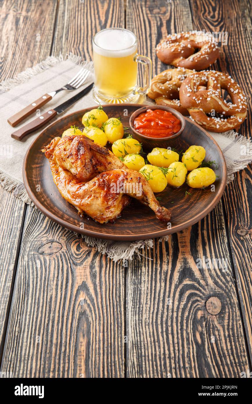 Bavarian roast chicken Hendl with boiled potatoes served with beer and ...