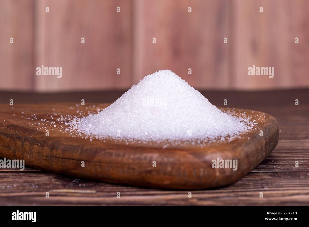 Granulated sugar. White refined sugar on wood background Stock Photo ...