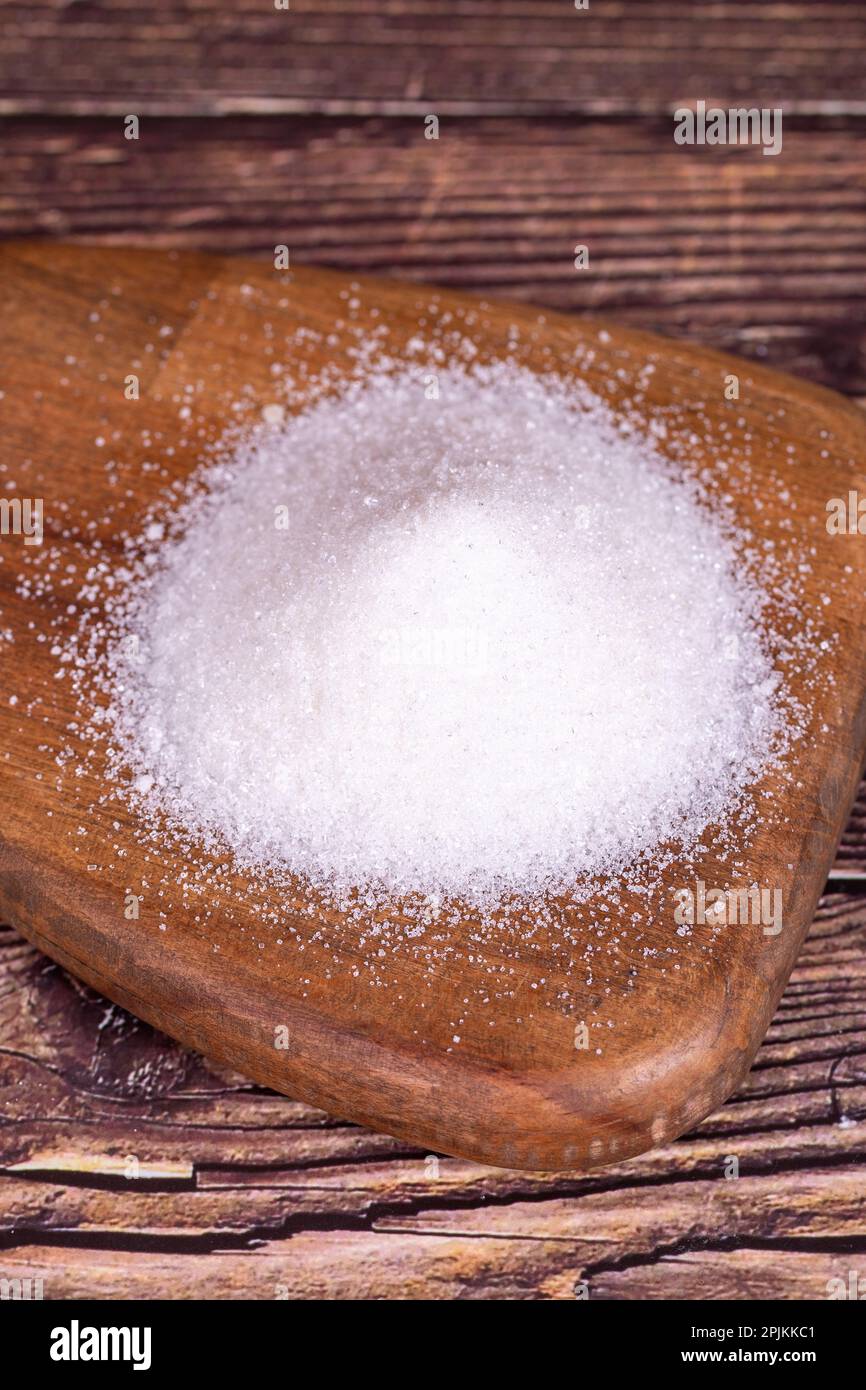 Granulated sugar. White refined sugar on wood background Stock Photo ...