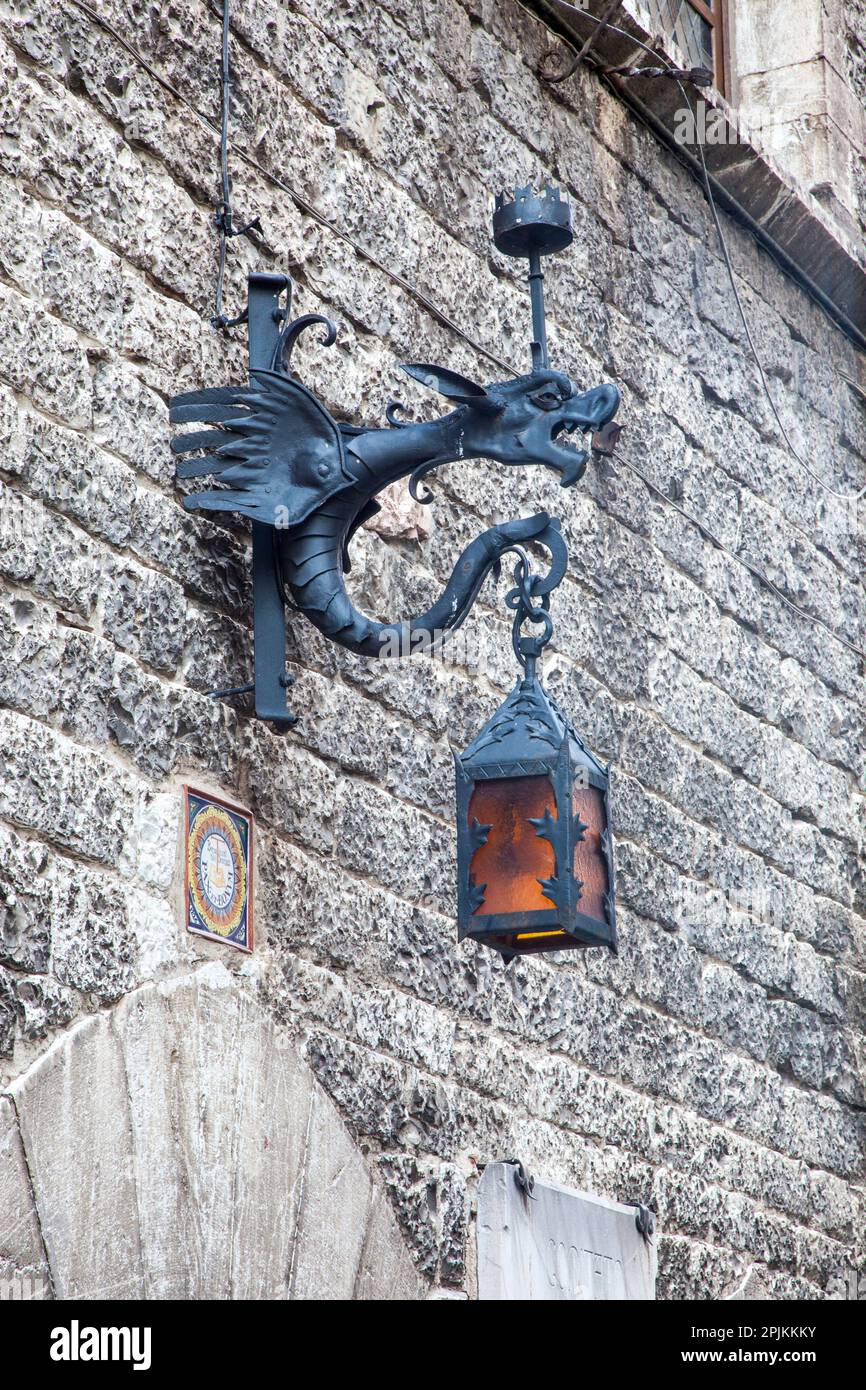 Italy, Umbria, Assisi. Old stone wall with Dragon Lantern Stock Photo ...
