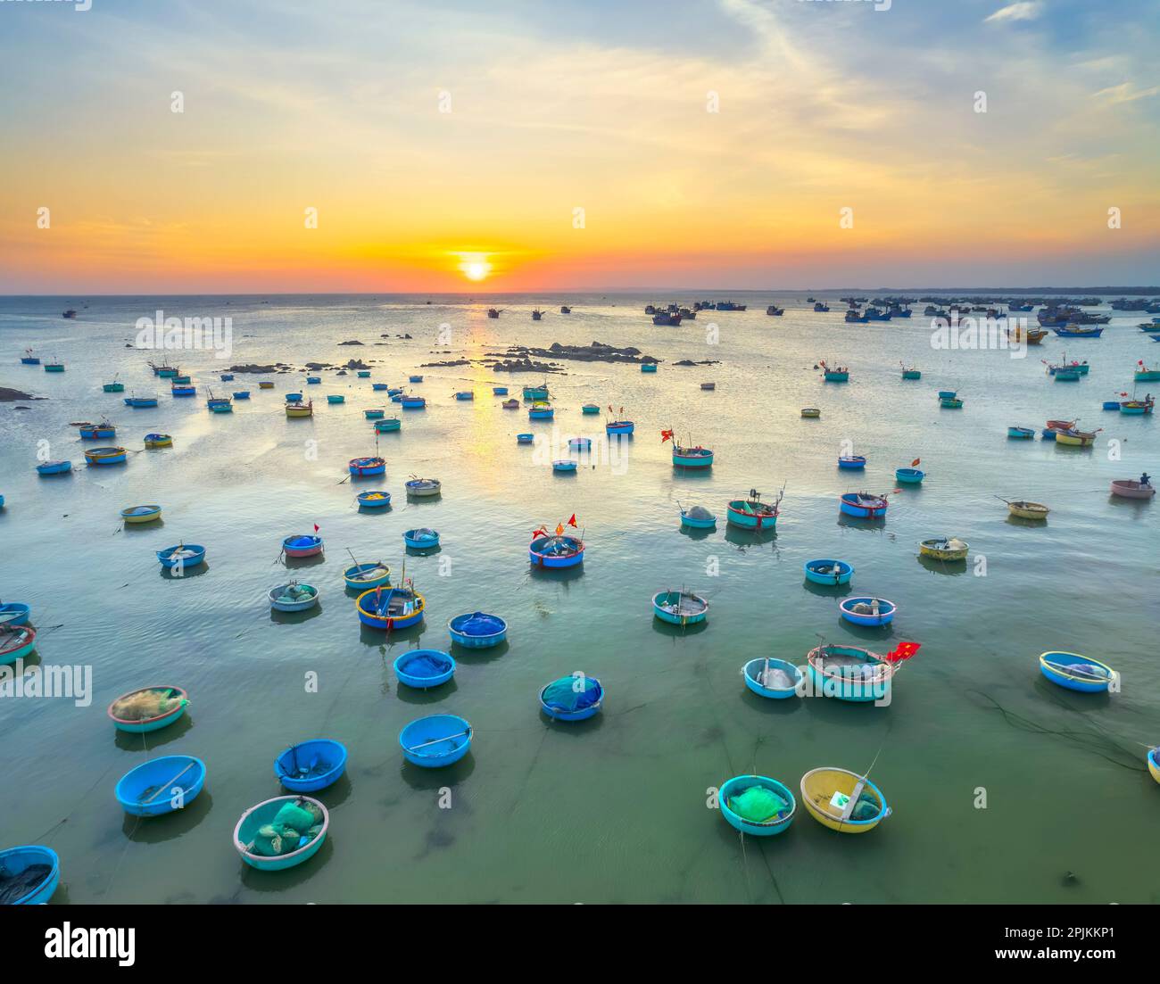 Aerial view of Mui Ne fishing village in sunset sky with hundreds of ...