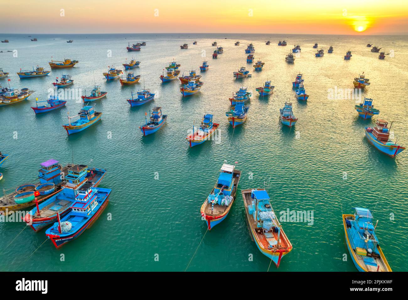 Aerial view of Mui Ne fishing village in sunset sky with hundreds of ...