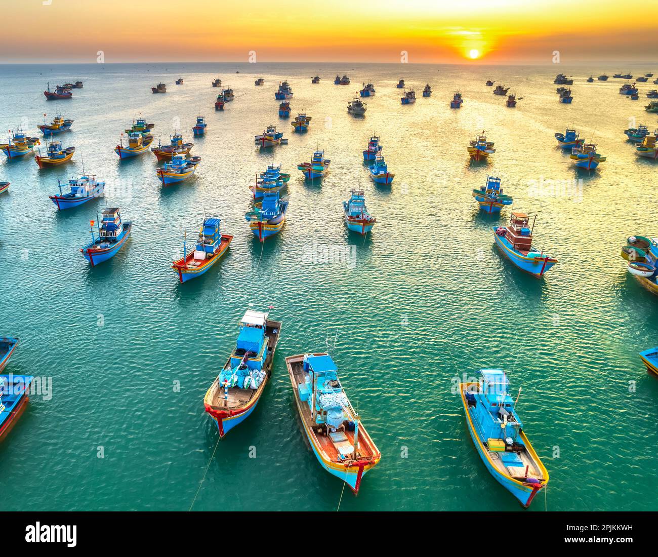 Aerial view of Mui Ne fishing village in sunset sky with hundreds of ...
