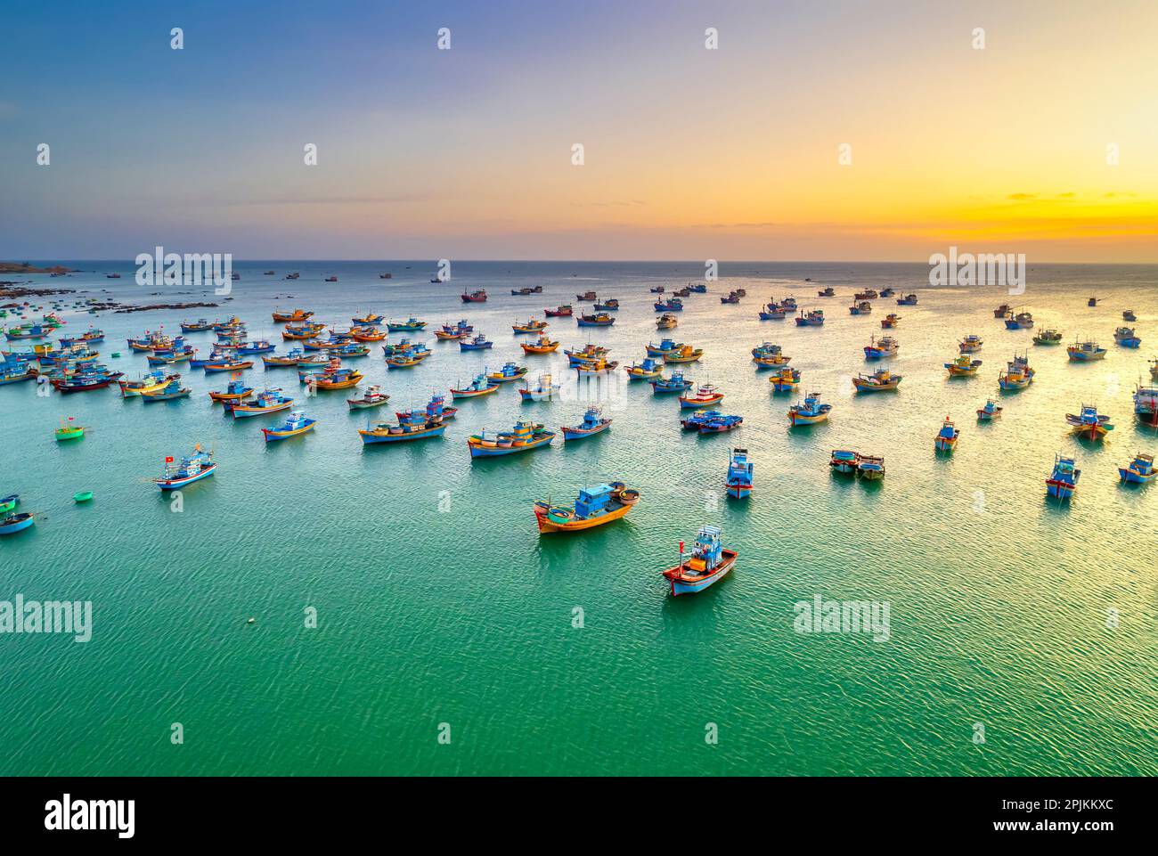 Aerial view of Mui Ne fishing village in sunset sky with hundreds of ...
