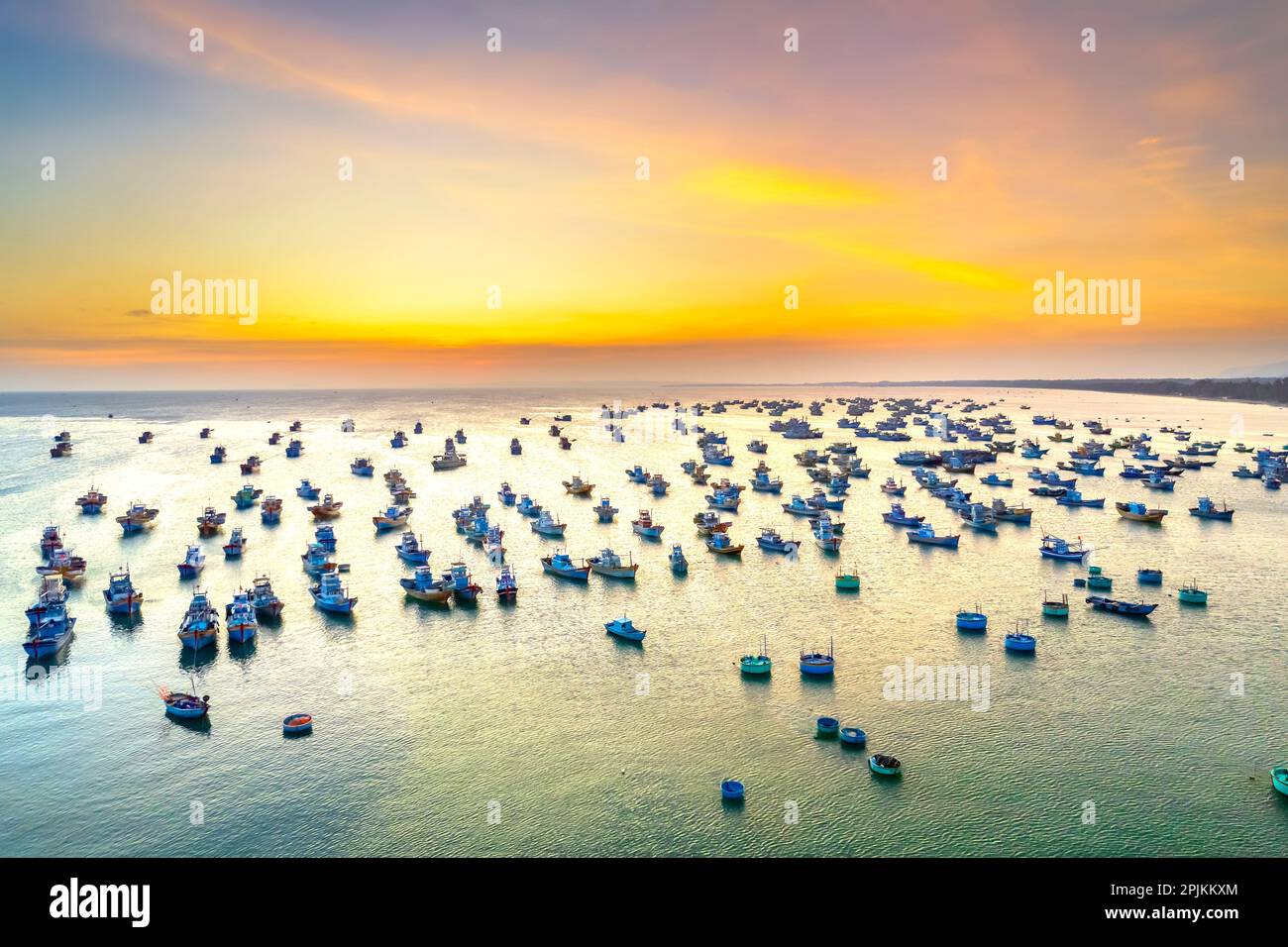 Aerial view of Mui Ne fishing village in sunset sky with hundreds of ...