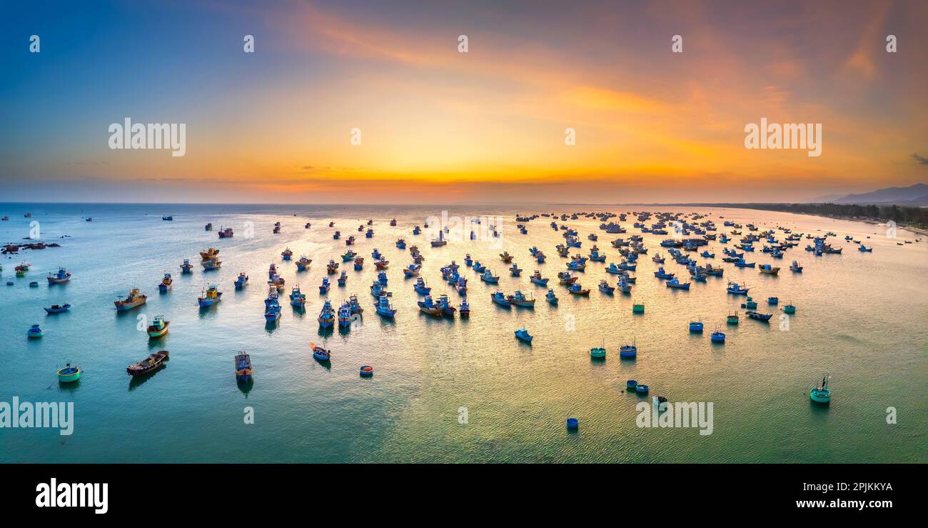 Aerial view of Mui Ne fishing village in sunset sky with hundreds of ...