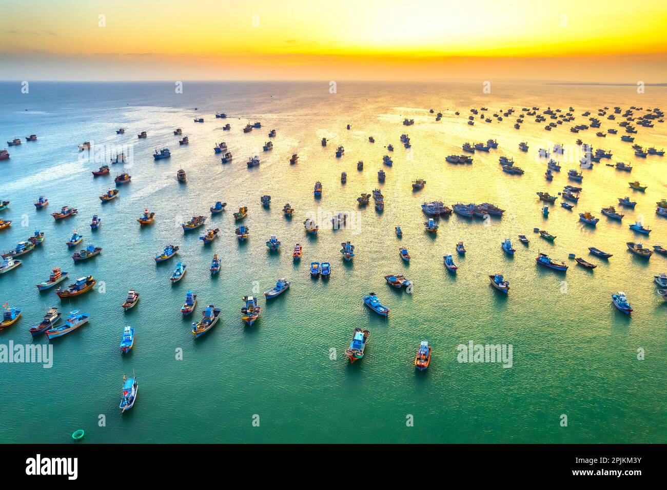 Aerial view of Mui Ne fishing village in sunset sky with hundreds of ...