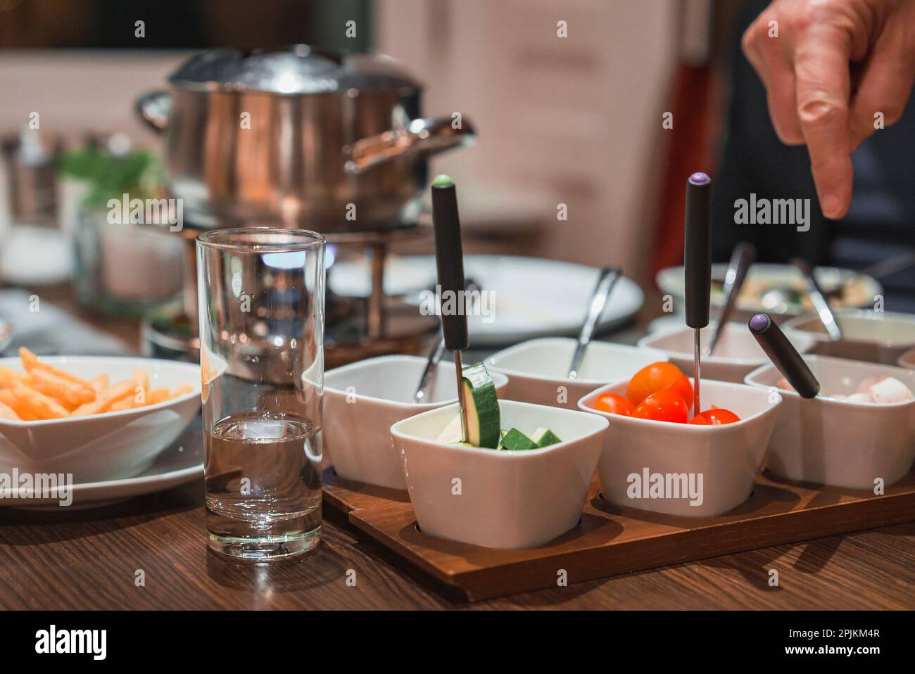 Finger pointing at salad in bowls on buffet counter Stock Photo - Alamy