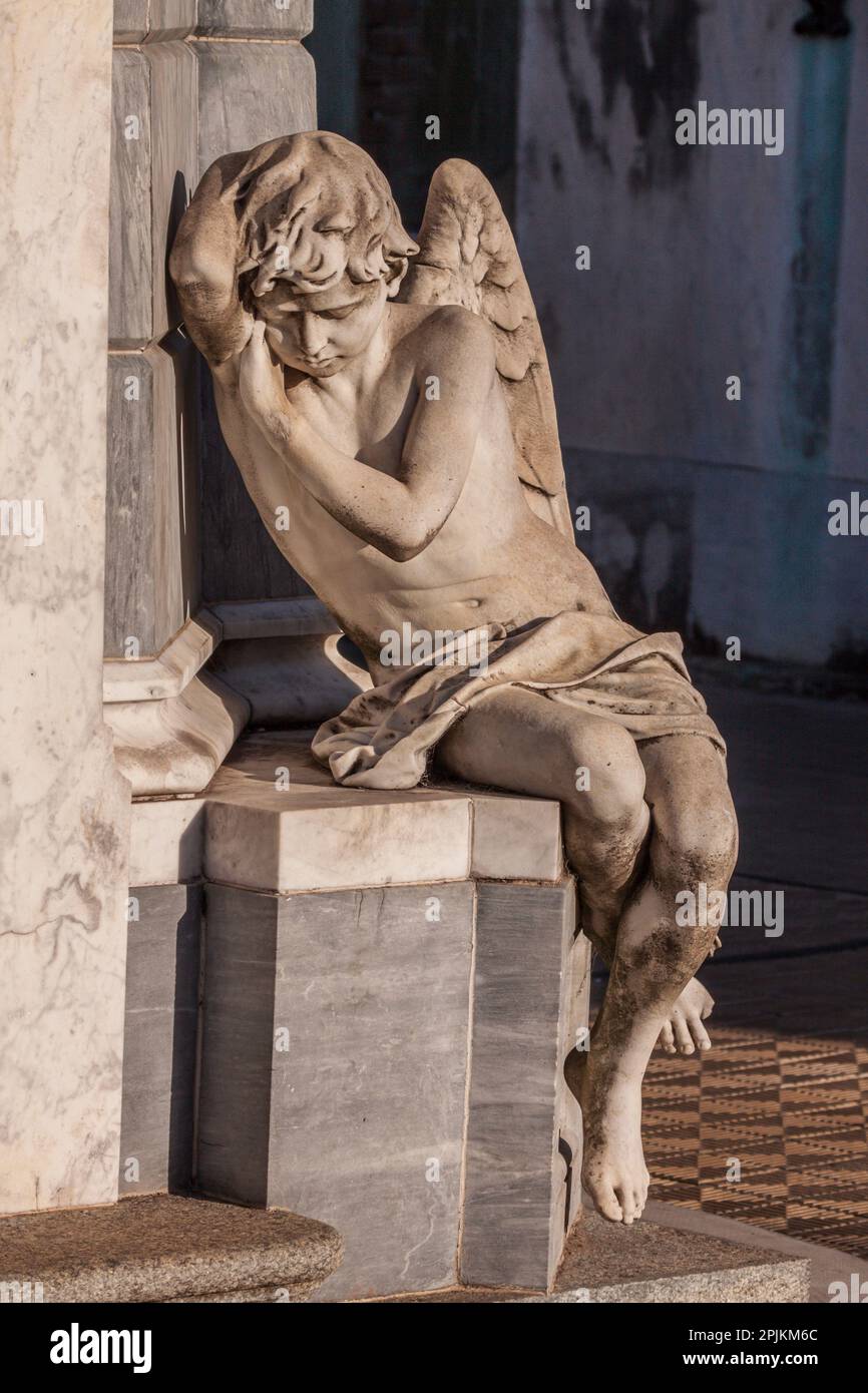 Argentina, Buenos Aires. Statue of an angel at the entrance to a tomb ...