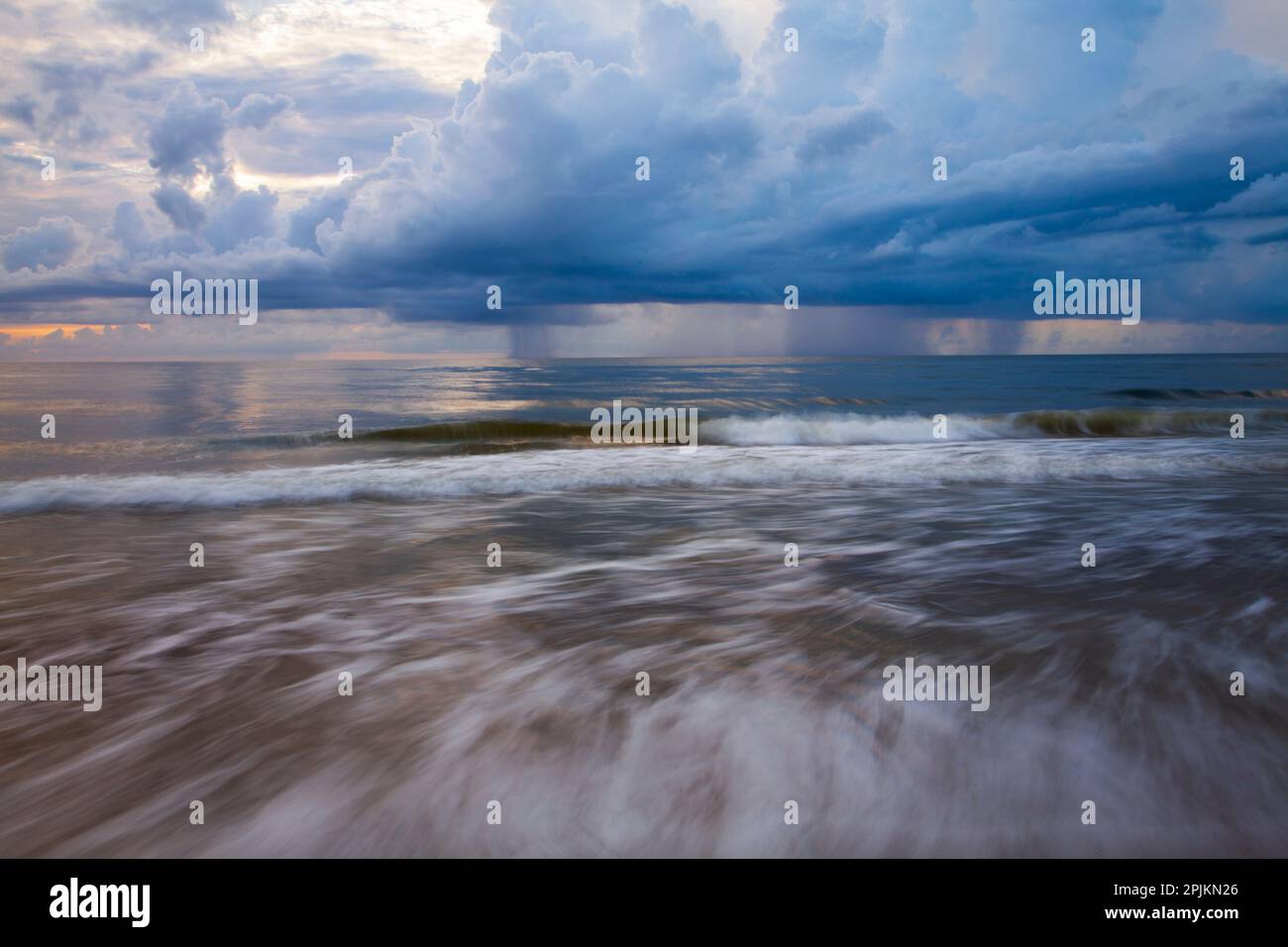 USA, Georgia, Tybee Island. Sunrise with clouds and reflections along ...