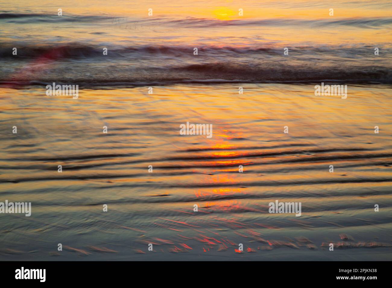 USA, Georgia, Tybee Island. Sunrise with ripples in the sand Stock ...