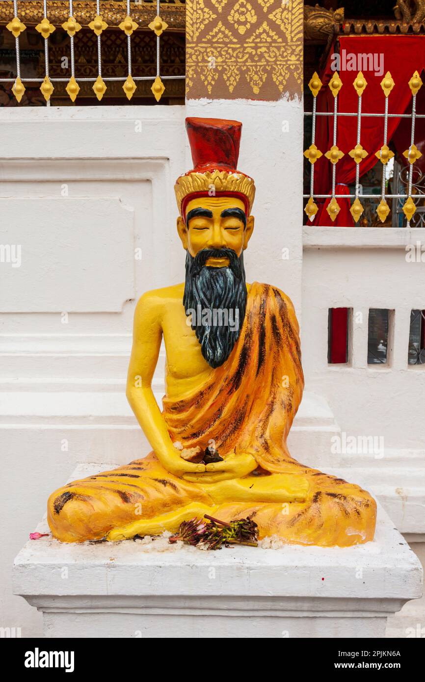 Laos, Luang Prabang. Statue of monk with long black beard Stock Photo ...