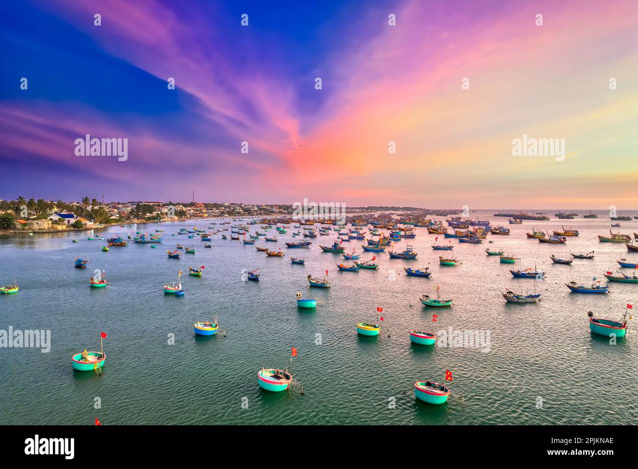 Aerial view of Mui Ne fishing village in sunset sky with hundreds of ...