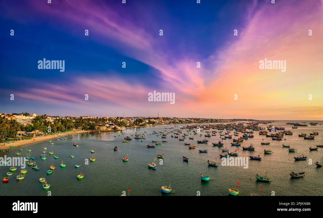 Aerial view of Mui Ne fishing village in sunset sky with hundreds of ...