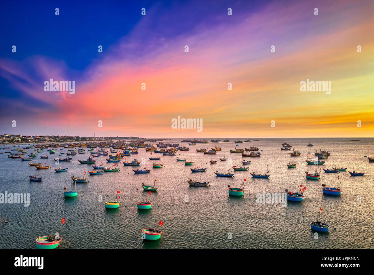 Aerial view of Mui Ne fishing village in sunset sky with hundreds of ...