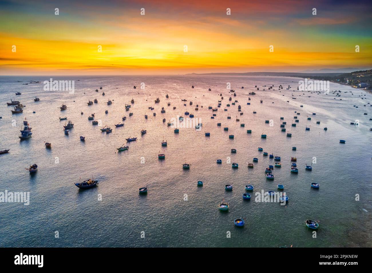 Aerial view of Mui Ne fishing village in sunset sky with hundreds of ...