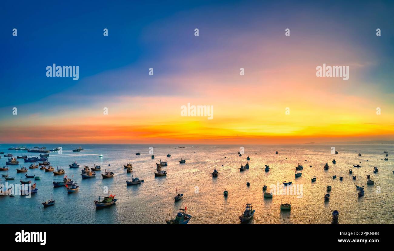 Aerial view of Mui Ne fishing village in sunset sky with hundreds of ...