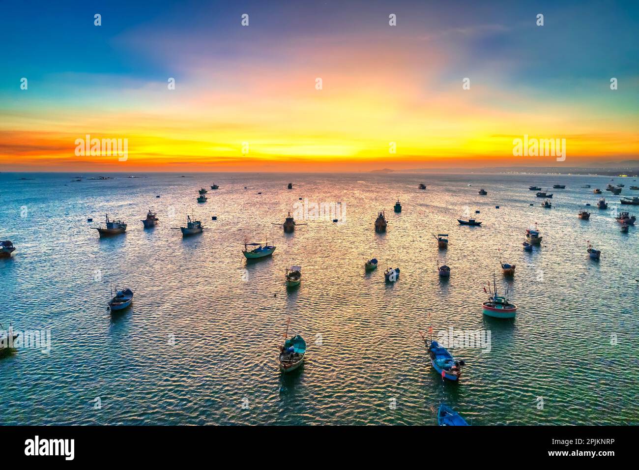Aerial view of Mui Ne fishing village in sunset sky with hundreds of ...