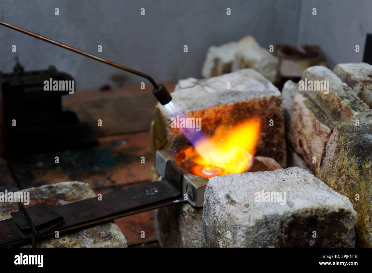 Flames burn brightly to melt unwanted silver down so it can be reused ...