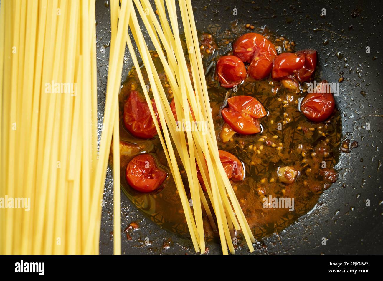 preparation of spaghetti with tomato sauce made with cherry tomatoes ...