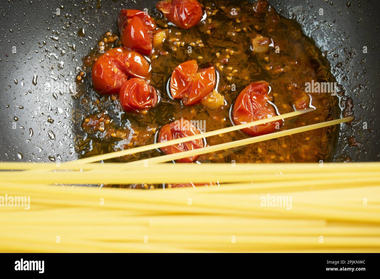 preparation of spaghetti with tomato sauce made with cherry tomatoes ...