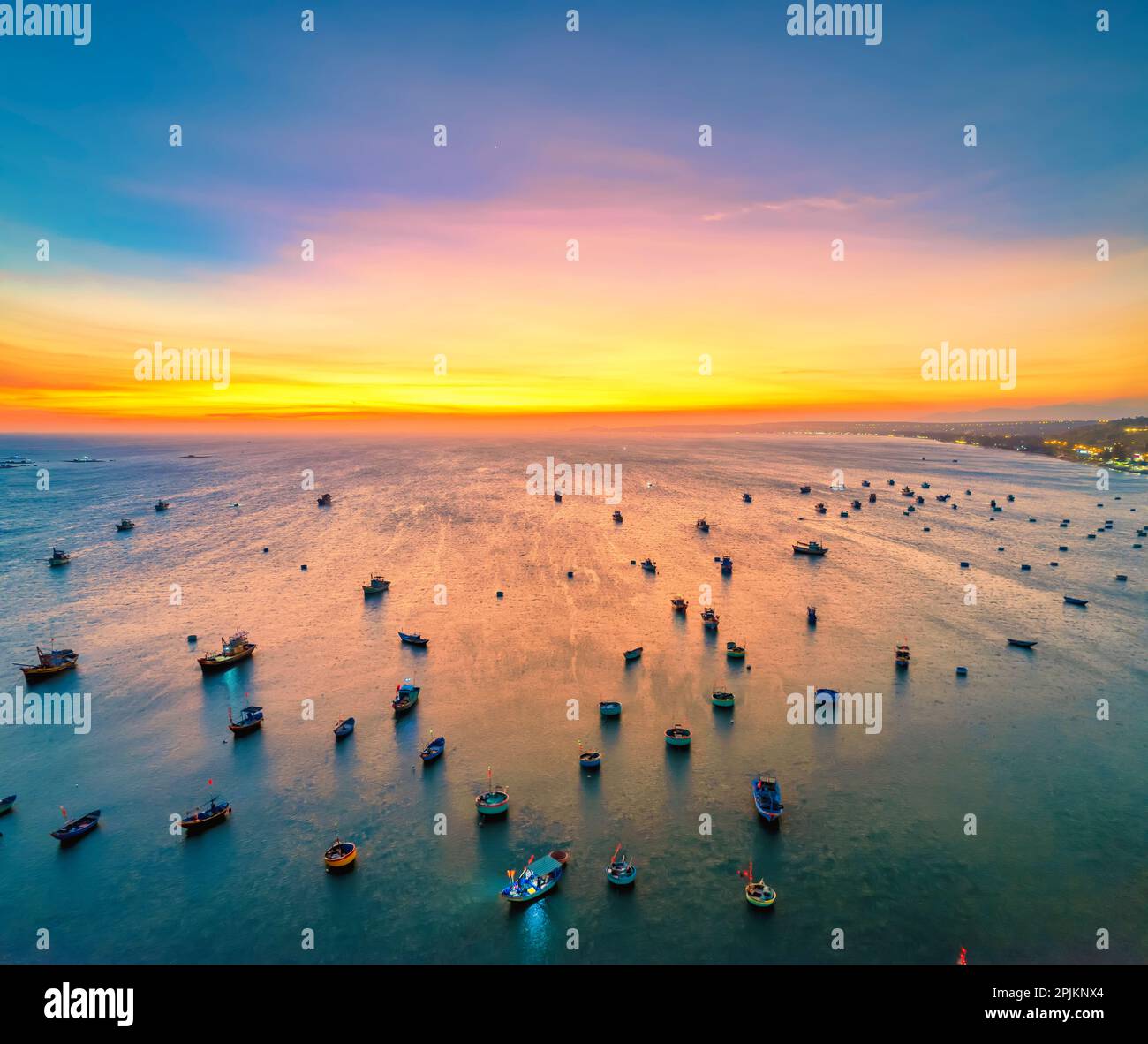 Aerial view of Mui Ne fishing village in sunset sky with hundreds of ...