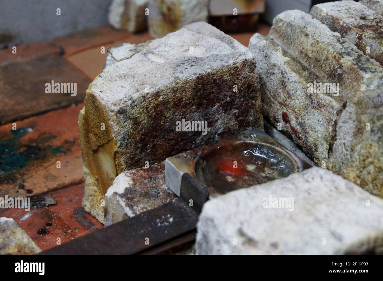 An empty crucible surrounded by fire bricks. It is waiting for the next ...