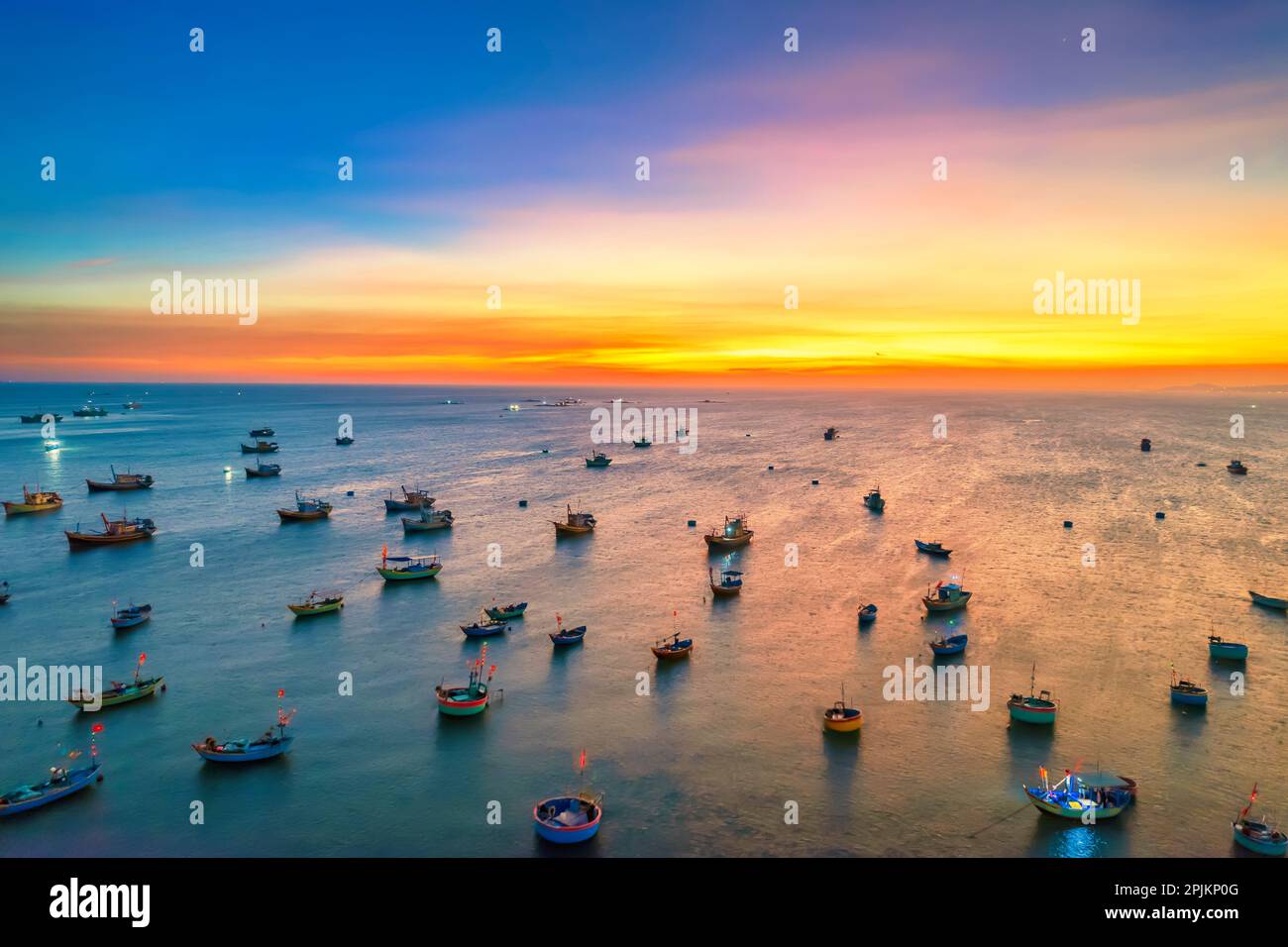 Aerial view of Mui Ne fishing village in sunset sky with hundreds of ...