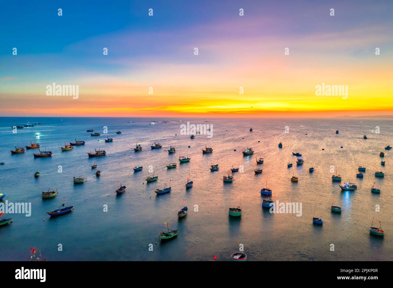 Aerial view of Mui Ne fishing village in sunset sky with hundreds of ...
