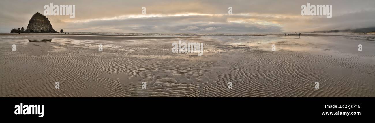 USA, Oregon. Cannon Beach and panorama of Haystack at sunset and low ...