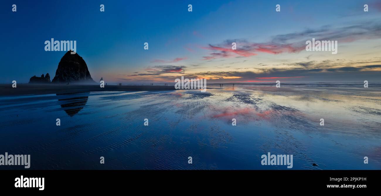 USA, Oregon. Cannon Beach and panorama of Haystack at sunset and low ...