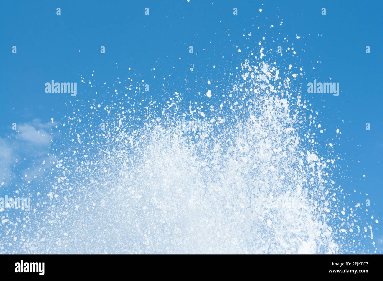 Cool and fresh water splashes on the clear blue sky background. White ...