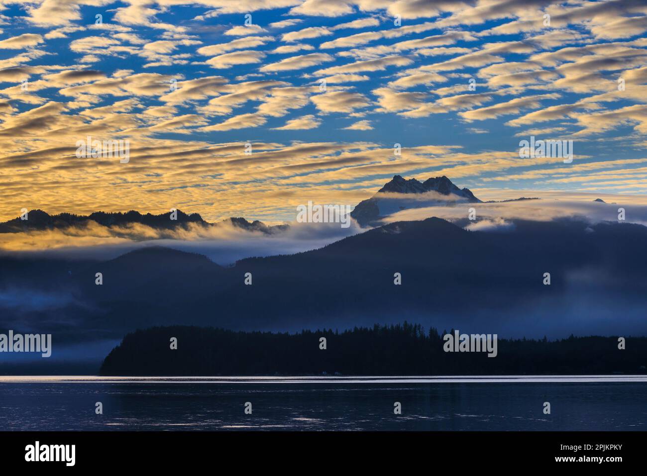 USA, Washington State, Seabeck. Sunset over Olympic Mountains and Hood ...