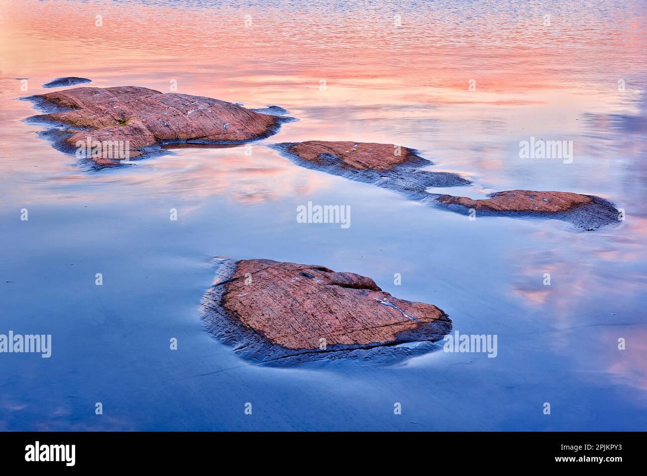 Canada, Manitoba, Paint Lake Provincial Park. Paint Lake. Exposed rocks ...