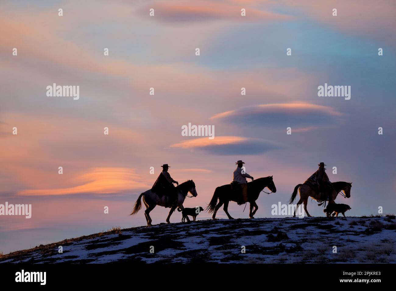 USA, Shell, Wyoming. Hideout Ranch cowboys and cowgirls silhouetted ...