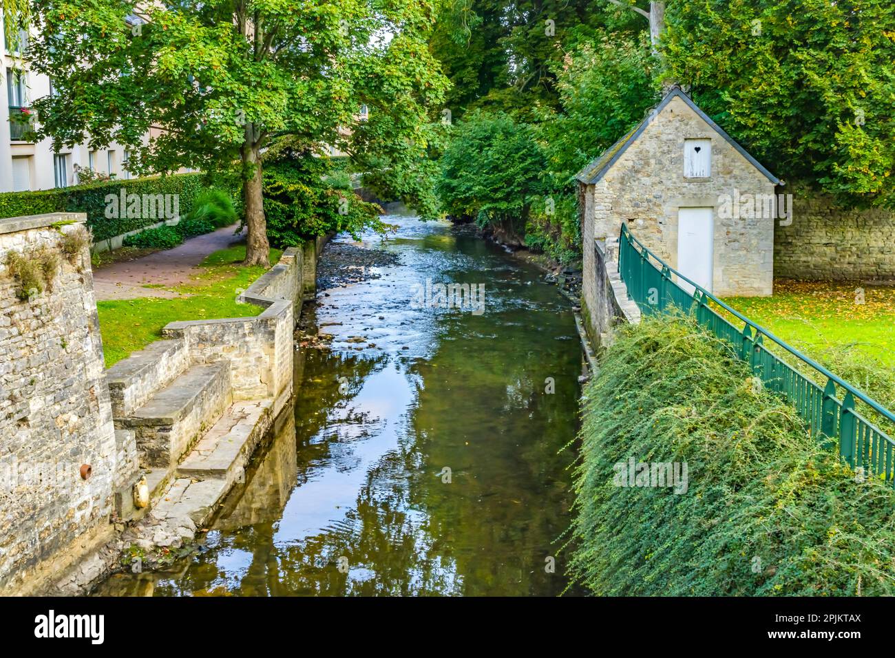 Colorful old buildings, Aure River reflection, Bayeux, Normandy, France ...
