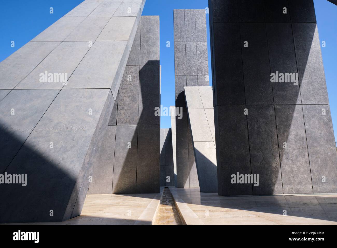 The grey, triangle shape of the artwork. At the Wahat Al Karama ...