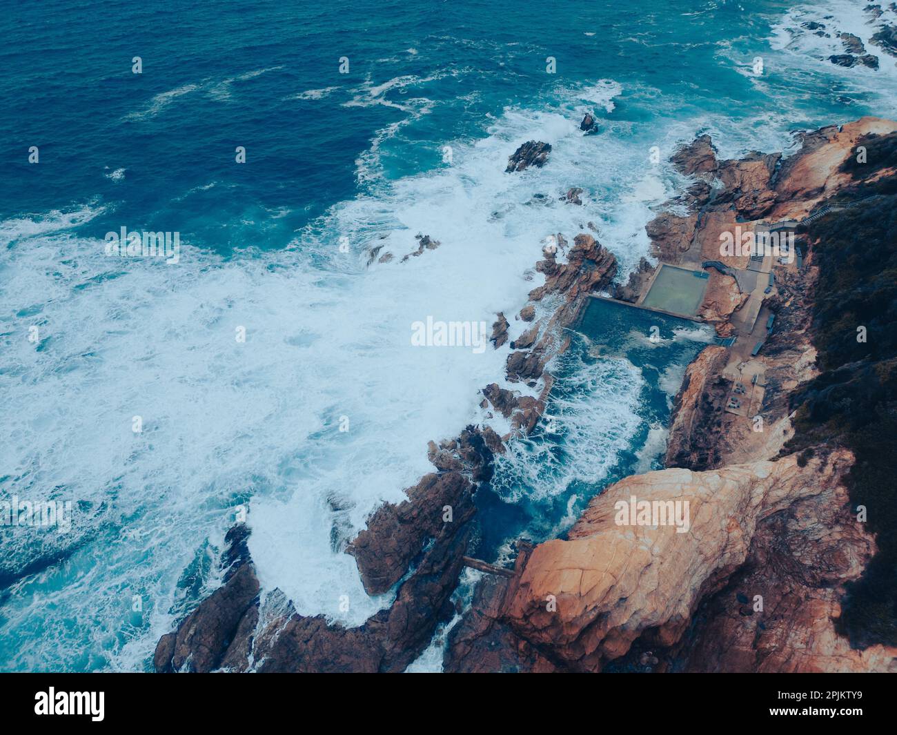 An aerial view of a stunning landscape featuring large rocks and sea ...