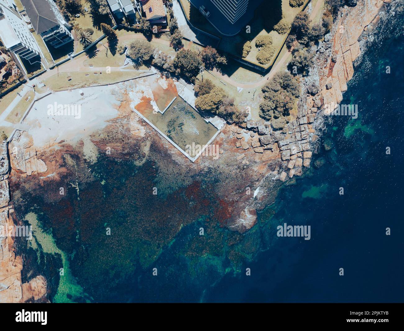 An aerial view of a tropical beach with rows of colorful beach houses ...