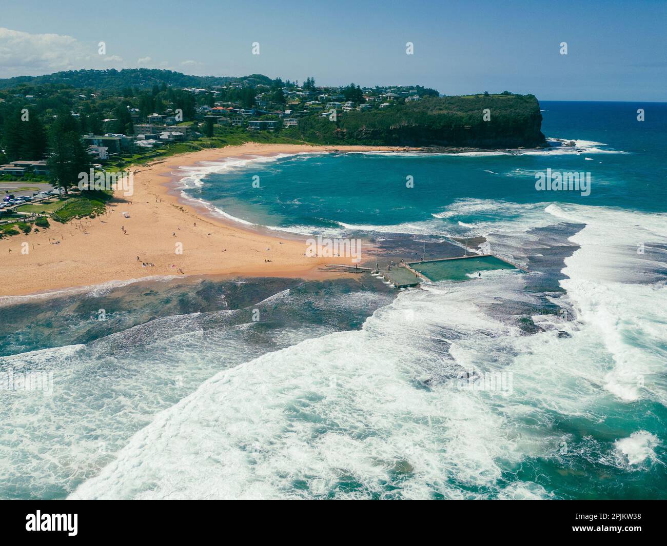 A picturesque coastline view of a beach town featuring rolling waves ...