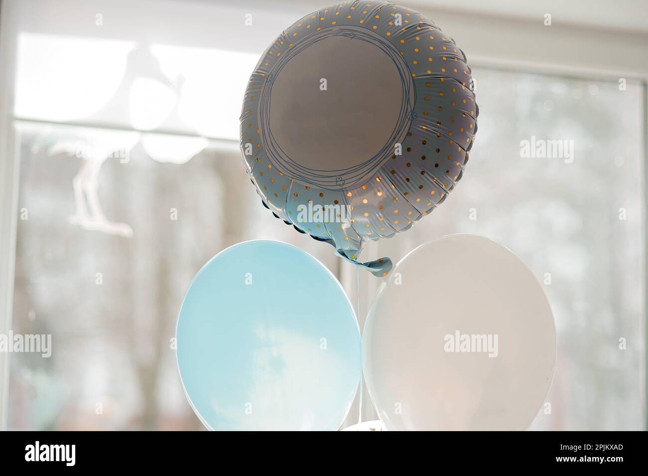 White and blue balloons. Multi-colored inflatable balls on a holiday ...