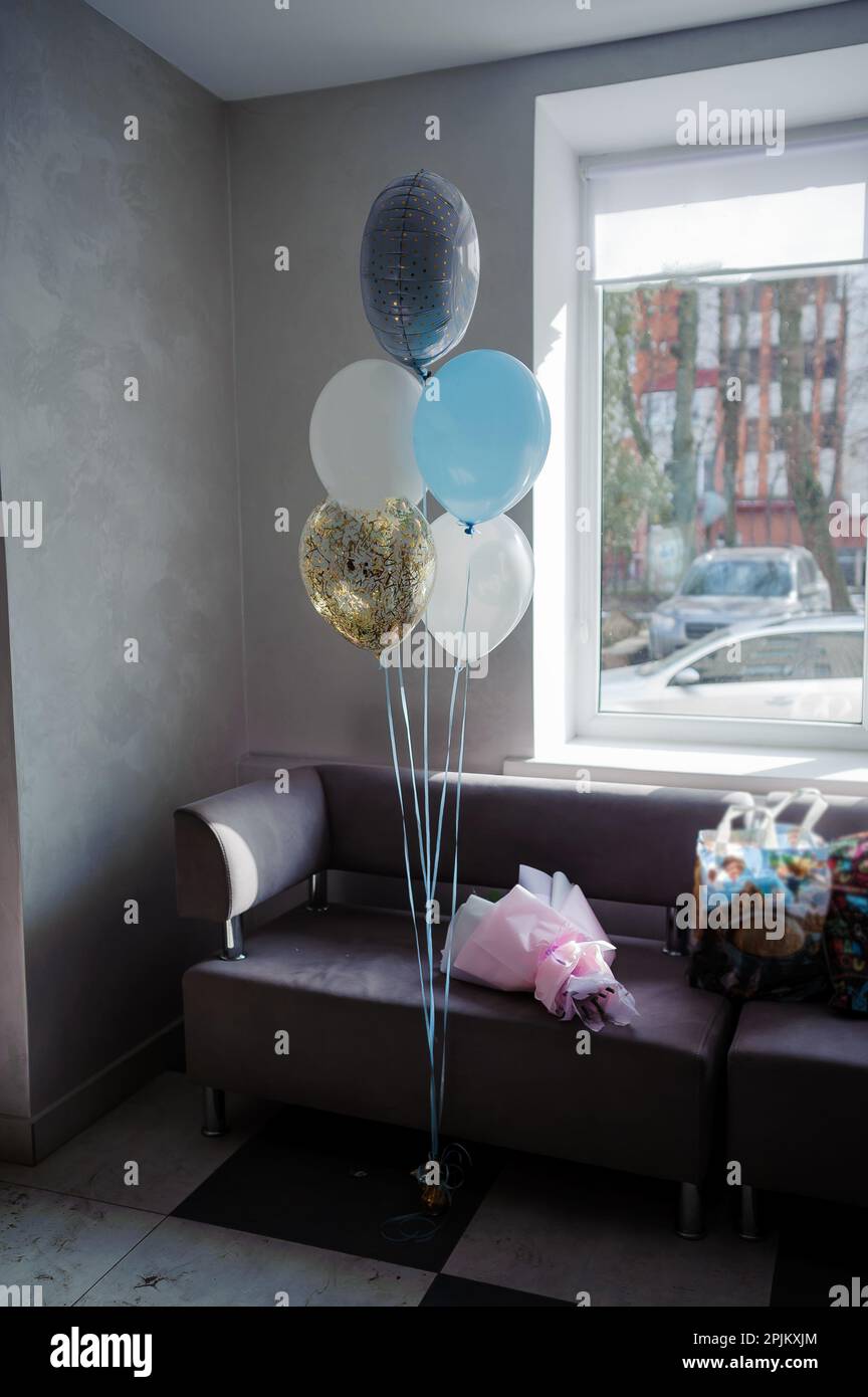 White and blue balloons. Multi-colored inflatable balls on a holiday ...